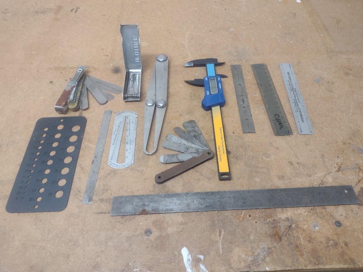 Assortment of Metal Measuring Sticks and Gauges | EstateSales.org